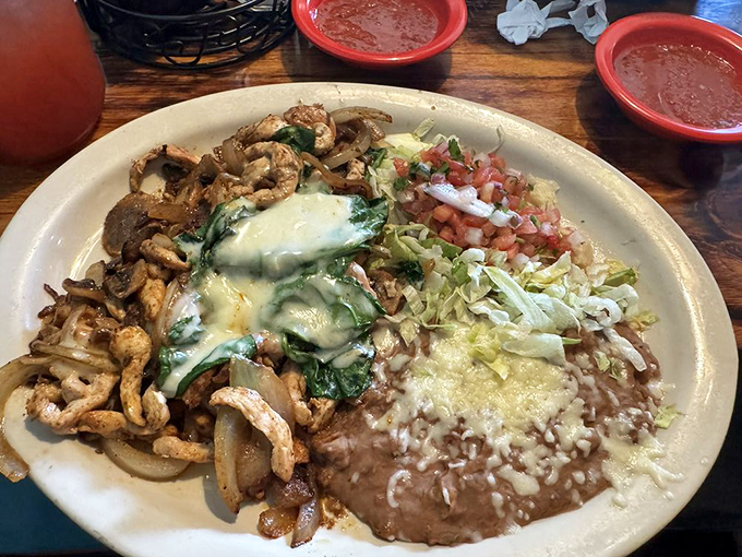 A plate that refuses to acknowledge portion control&mdash;tender chicken, melted cheese, and beans that make you question why you ever eat anywhere else.