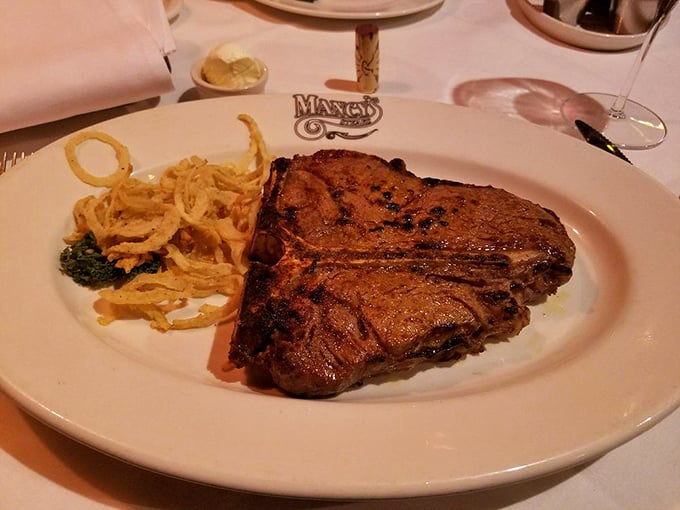 The porterhouse arrives like a carnivore's dream&mdash;perfectly charred exterior giving way to a blushing interior, with those crispy onion straws standing guard.