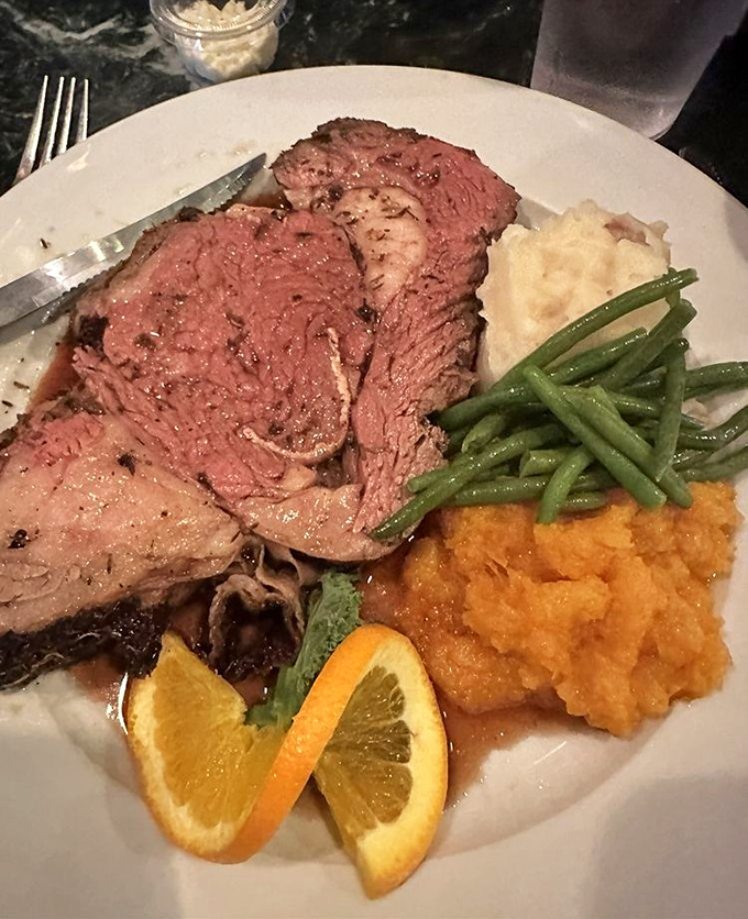 Prime rib that doesn't just fall off the bone—it practically leaps onto your fork, accompanied by sides that refuse to be mere afterthoughts.