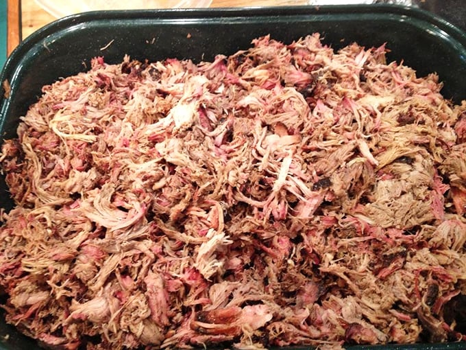 A tray of pulled pork that's been treated with the patience and respect it deserves – strands of pink-tinged meat ready for their sandwich destiny.