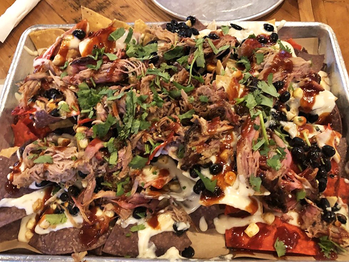 Pulled pork nachos that blur the line between appetizer and main course &ndash; a mountain of tortilla chips supporting a delicious avalanche of smoky goodness.