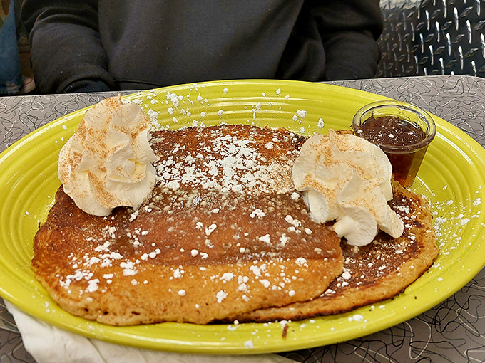 These pancakes don't just sit on the plate&mdash;they command it, with whipped cream clouds and a dusting of powdered sugar that sparkles like morning frost.