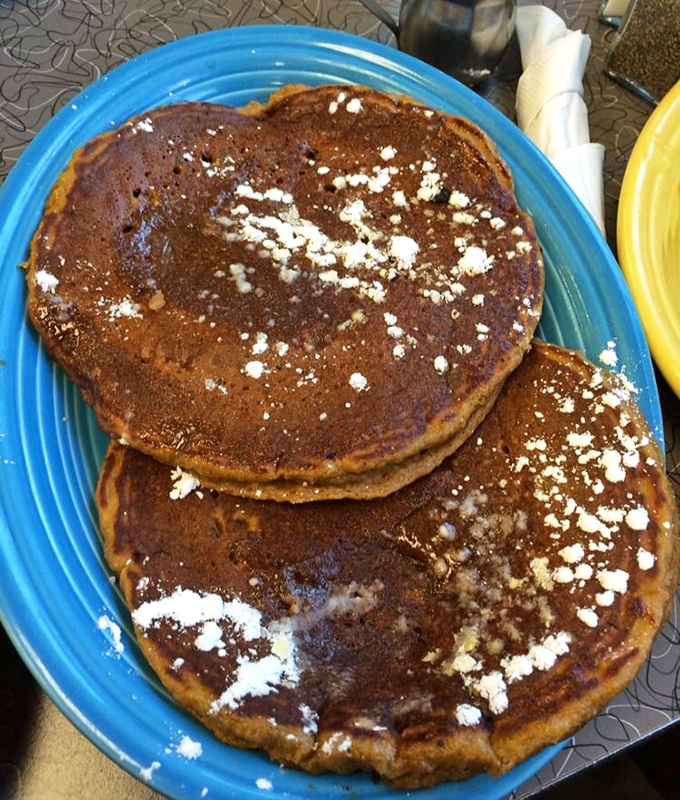 Pumpkin pancakes that could double as manhole covers, yet somehow float on your fork like autumn clouds.