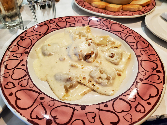 Ravioli swimming in cream sauce on heart-patterned plates&mdash;because sometimes food should dress up for the occasion too.