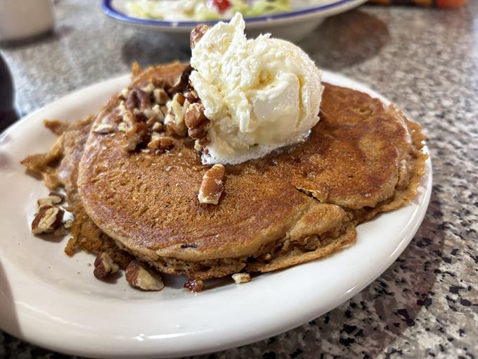 Pancakes crowned with a melting pat of butter and sprinkled with nuts&mdash;like a breakfast throne for your taste buds' coronation.