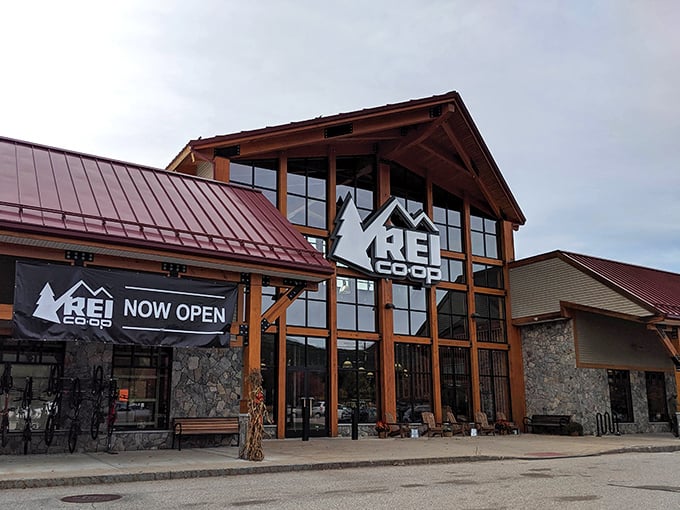 REI's timber-framed entrance looks sturdy enough to survive both Black Friday crowds and actual mountain expeditions.
