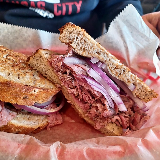 The classic Reuben in its natural habitat &ndash; pink corned beef peeking through layers of sauerkraut and Swiss, a sandwich that demands to be noticed.