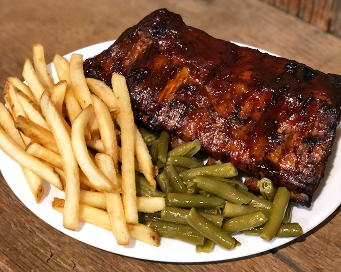 Fall-off-the-bone ribs that render silverware optional. The caramelized exterior tells you everything you need to know about flavor priorities here.