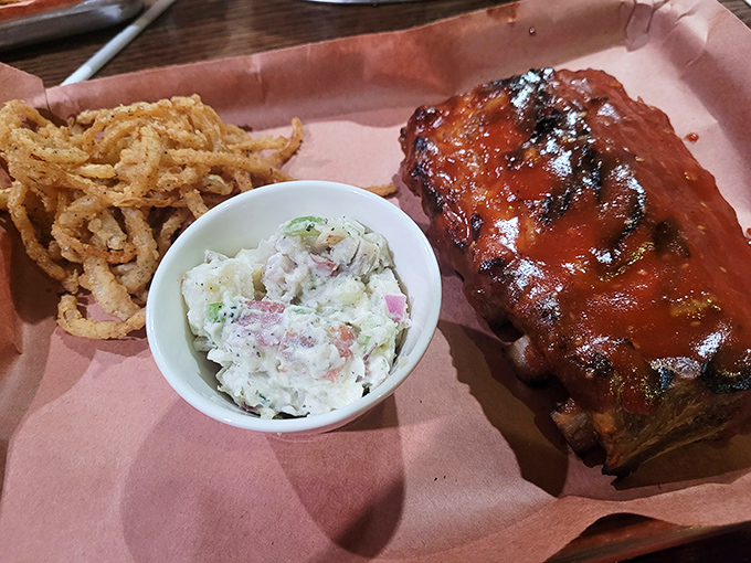 These ribs fall off the bone like autumn leaves, accompanied by sides that complete this comfort food symphony.