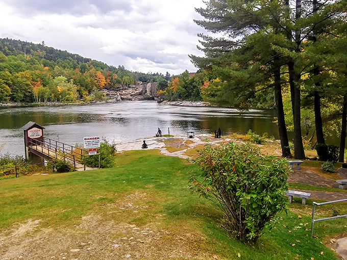 The Rumford Falls Trail offers front-row seats to nature's power show, where the Androscoggin River tumbles dramatically through a landscape dressed in autumn finery.