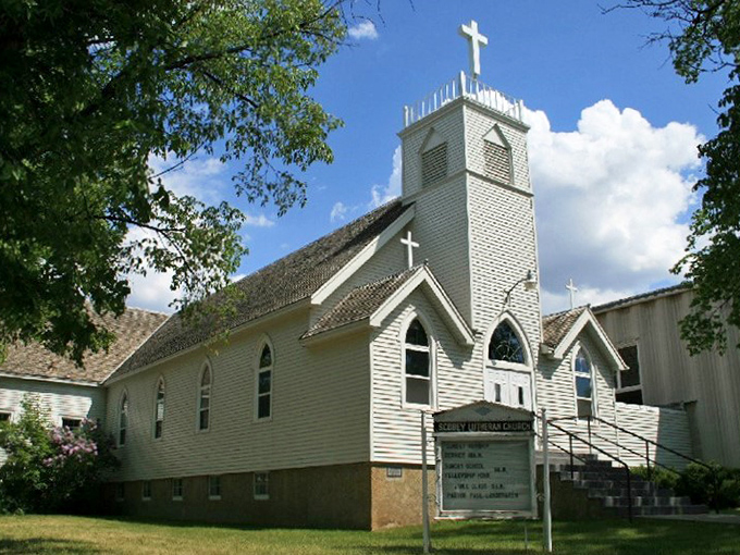 Scobey's Lutheran Church stands tall against the Big Sky, its white clapboard exterior and steeple a beacon of faith visible for miles across the prairie.