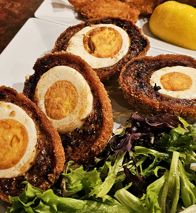 Scotch eggs that would make a Scottish grandmother weep with joy &ndash; crispy exterior giving way to savory sausage and that perfect soft-boiled center.