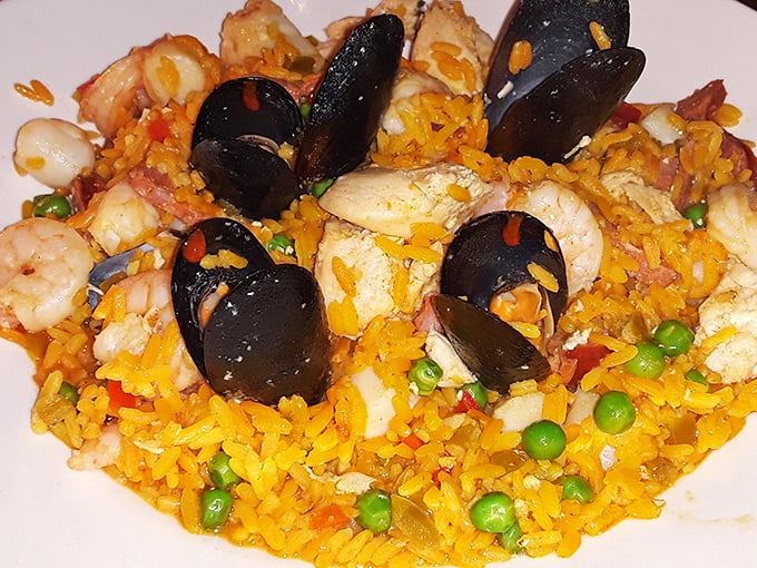 This seafood paella isn't just dinner&mdash;it's an underwater neighborhood meeting where shrimp, mussels, and rice all showed up wearing their Sunday best.