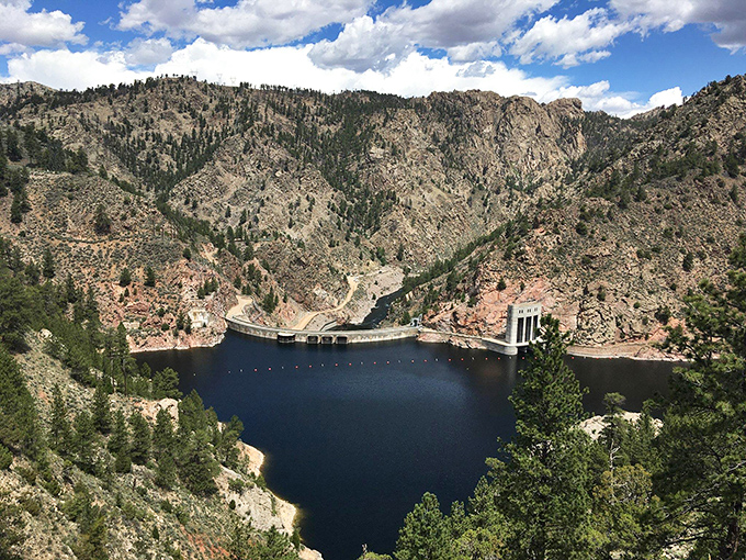 The dam that started it all &ndash; a concrete masterpiece nestled between ancient rock faces, holding back 20,000 acres of brilliant blue.