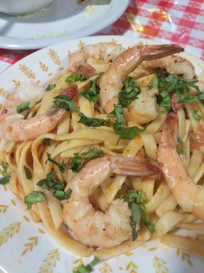 Shrimp scampi swimming in enough garlic butter to ward off vampires and attract every food lover within miles.