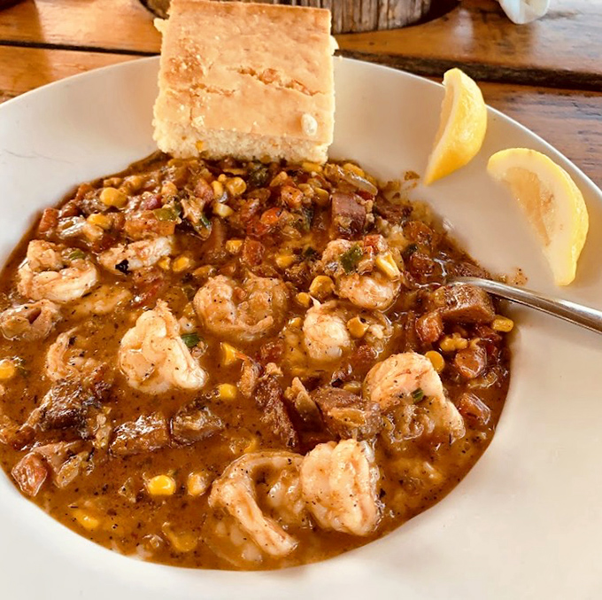 Shrimp and grits that would make a Southerner weep with joy. Plump shrimp swimming in savory goodness alongside a perfect cornbread sidekick.