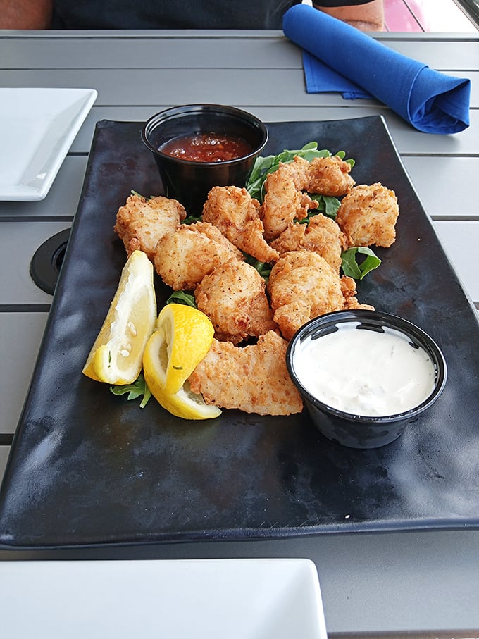 Crispy fried shrimp arranged like edible jewelry, with dipping sauces standing by for their grand entrance into flavor town.