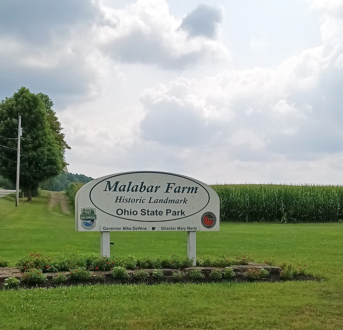 The entrance sign stands sentinel between cornfields and green pastures &ndash; like the world's most wholesome welcome mat.