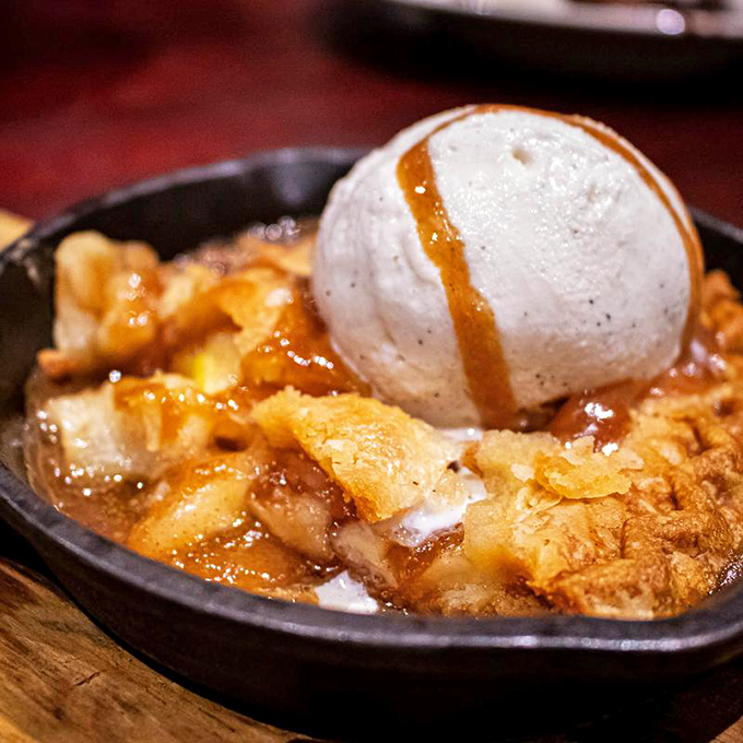 The sizzling apple pie arrives like a warm hug in dessert form. That melting ice cream is doing exactly what we're all thinking.