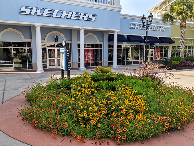 Skechers knows comfort is king. Their storefront, framed by vibrant seasonal flowers, invites tired feet to find their happy place.