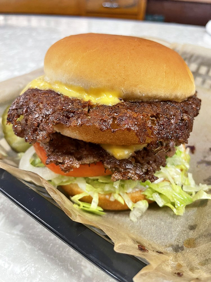 Two smashed patties creating a masterpiece of crispy, cheesy perfection that'll have you planning tomorrow's lunch before finishing today's.