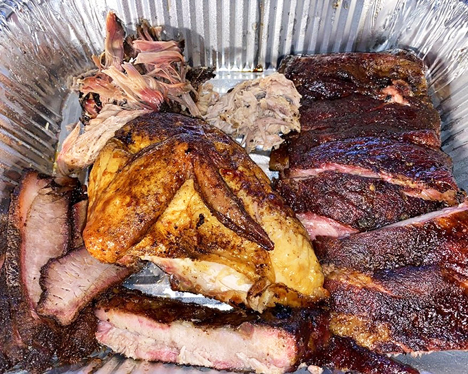 A barbecue feast fit for royalty: chicken, ribs, and brisket sharing a tray in perfect harmony.