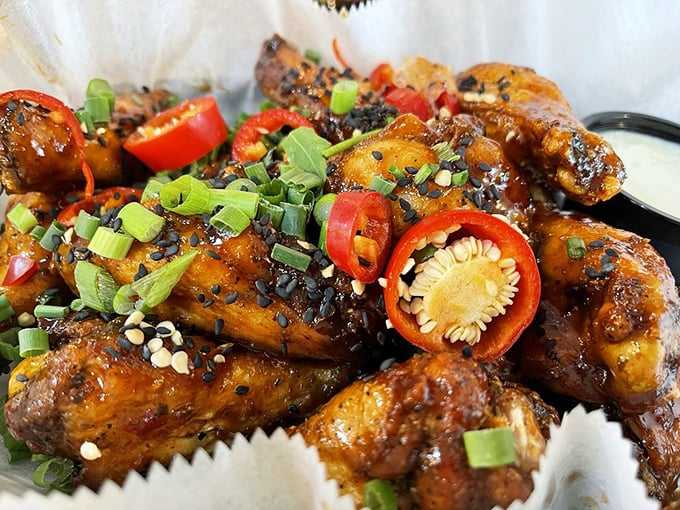 Wings adorned with vibrant toppings that pop like fireworks of flavor&mdash;proof that sometimes the messiest foods create the cleanest plates.
