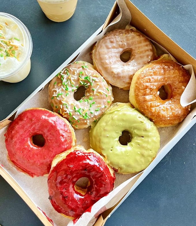 The holy grail of donut boxes – a rainbow of glazes from classic to adventurous, each one begging to be your new favorite.