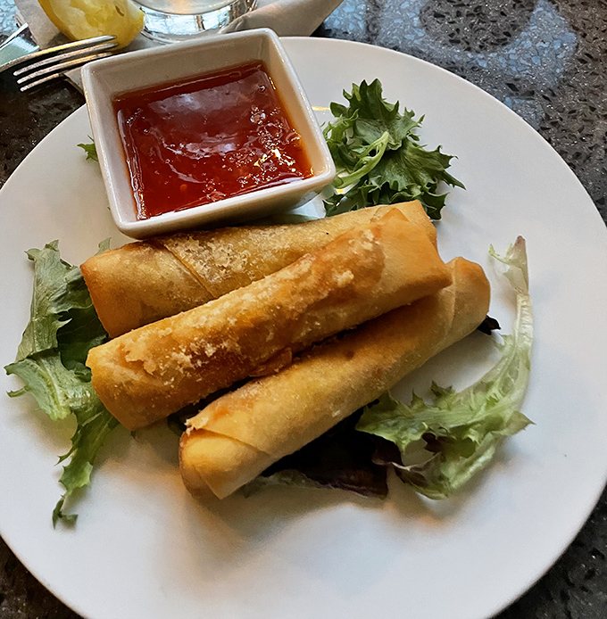 Spring rolls so perfectly crisp, they make that satisfying crunch that announces to everyone nearby: "Yes, I'm having the best bite at the table."