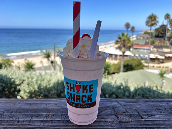 A strawberry shake with whipped cream and that classic red-striped straw&mdash;proof that happiness can indeed be sipped through a straw.