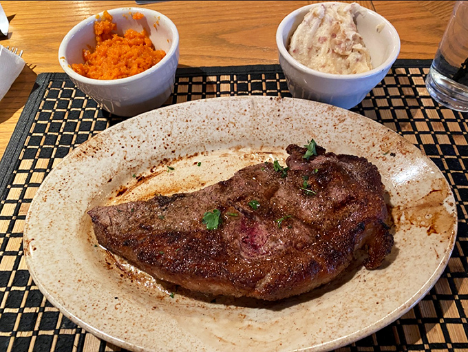 This strip steak showcases the kind of perfect sear that separates the amateurs from the true grill masters.