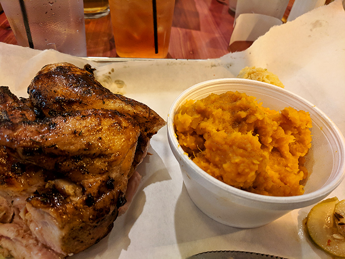 Golden-hued sweet potato mash alongside perfectly smoked chicken—proof that sides aren't afterthoughts but co-stars in this meaty production.