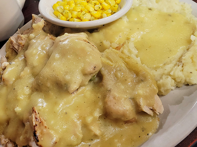 Swiss steak and mashed potatoes swimming in gravy with a side of corn&mdash;comfort food that hugs you from the inside out.
