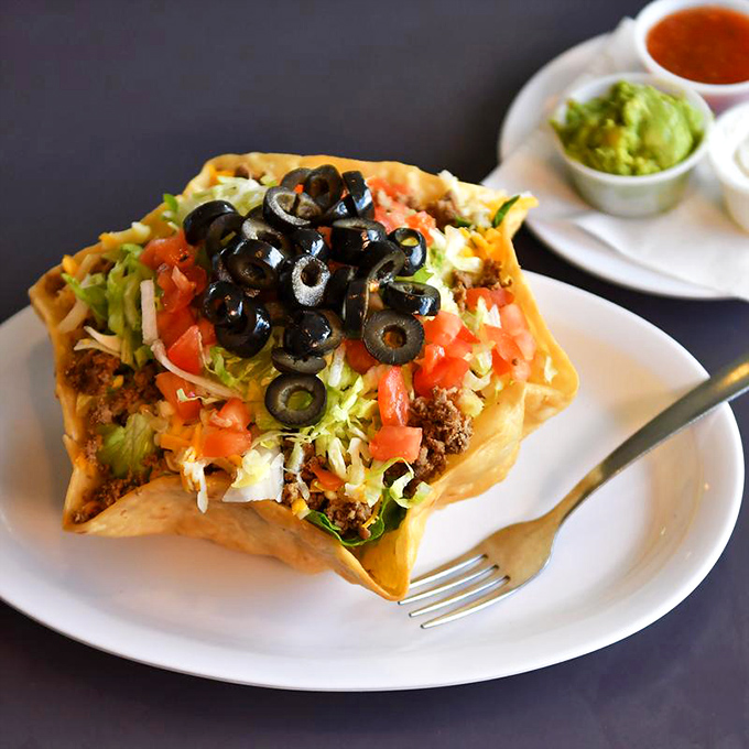 This taco salad isn't just a meal, it's an edible bowl of joy topped with a confetti of fresh ingredients.