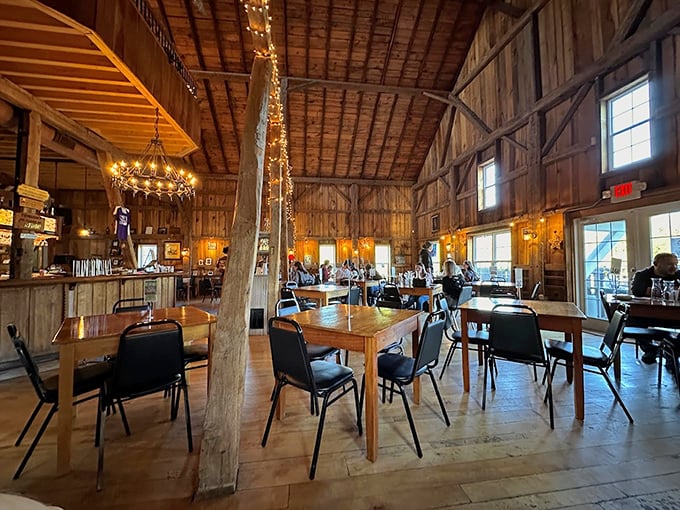 Inside the tasting room, exposed beams and string lights create the kind of rustic elegance that makes wine taste even better.