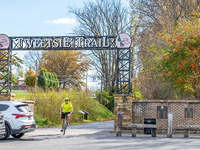 The Tweetsie Trail entrance stands like a portal to adventure, where cyclists and hikers can time-travel along the historic railroad path.
