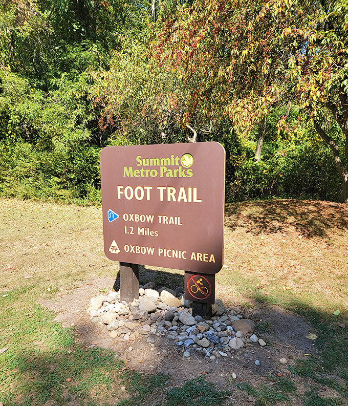 Every great adventure begins with a sign. The Oxbow Trail promises 1.2 miles of discovery—just enough to earn that picnic lunch.