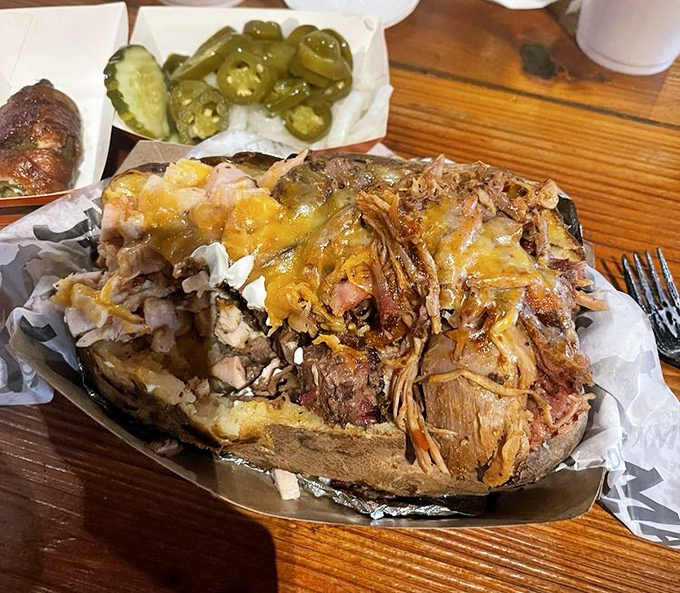 The Triple Threat potato isn't just a side dish&mdash;it's a full-blown commitment to excellence, where brisket, turkey, and pork unite atop a fluffy spud throne.