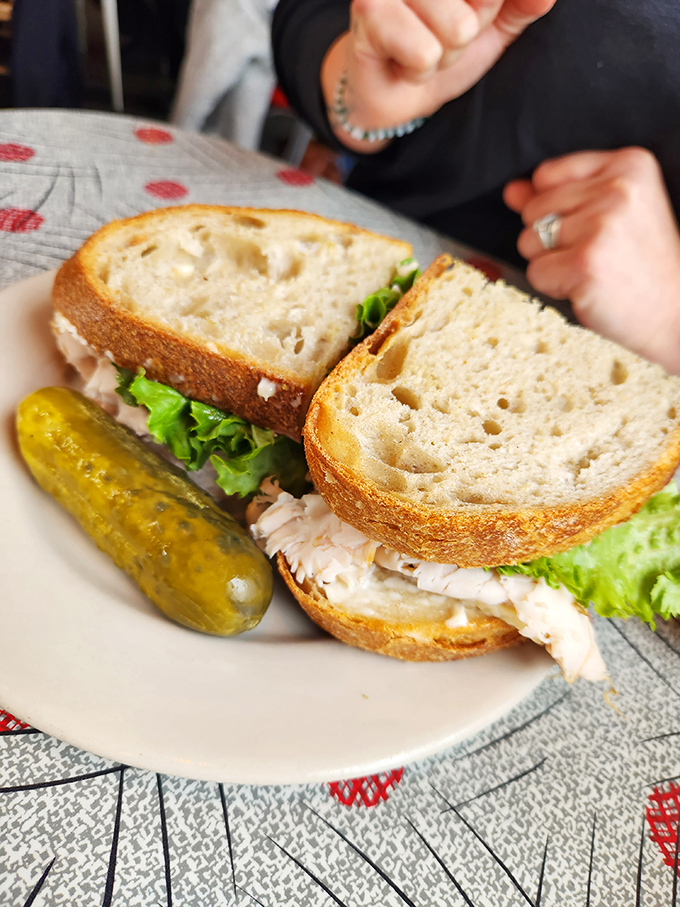 This isn't your average sandwich; piled high with turkey, it's comfort food paired perfectly with a crunchy pickle spear.