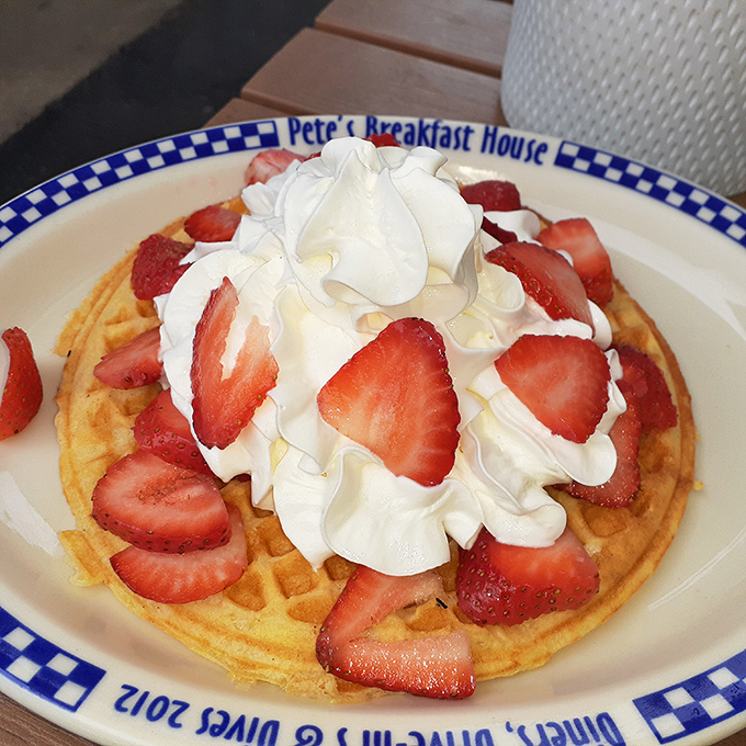 Strawberry waffle nirvana—where the whipped cream mountains meet the strawberry valleys in perfect breakfast harmony.