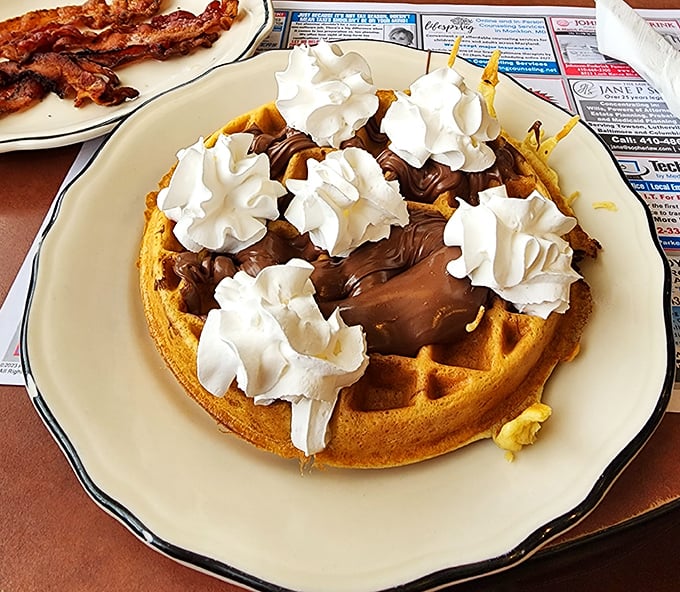 Chocolate meets waffle in a breakfast romance for the ages, topped with whipped cream islands that slowly melt into sweet, golden valleys.