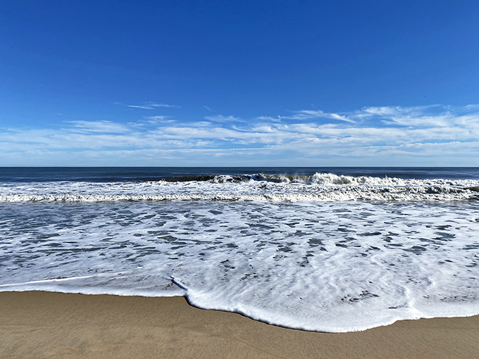 Ocean foam dances on shore like champagne bubbles, celebrating another perfect day at the water's edge.