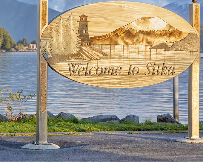 Sitka's welcome sign captures the essence of the place—a volcano, a lighthouse, and the promise of wilderness just beyond civilization.