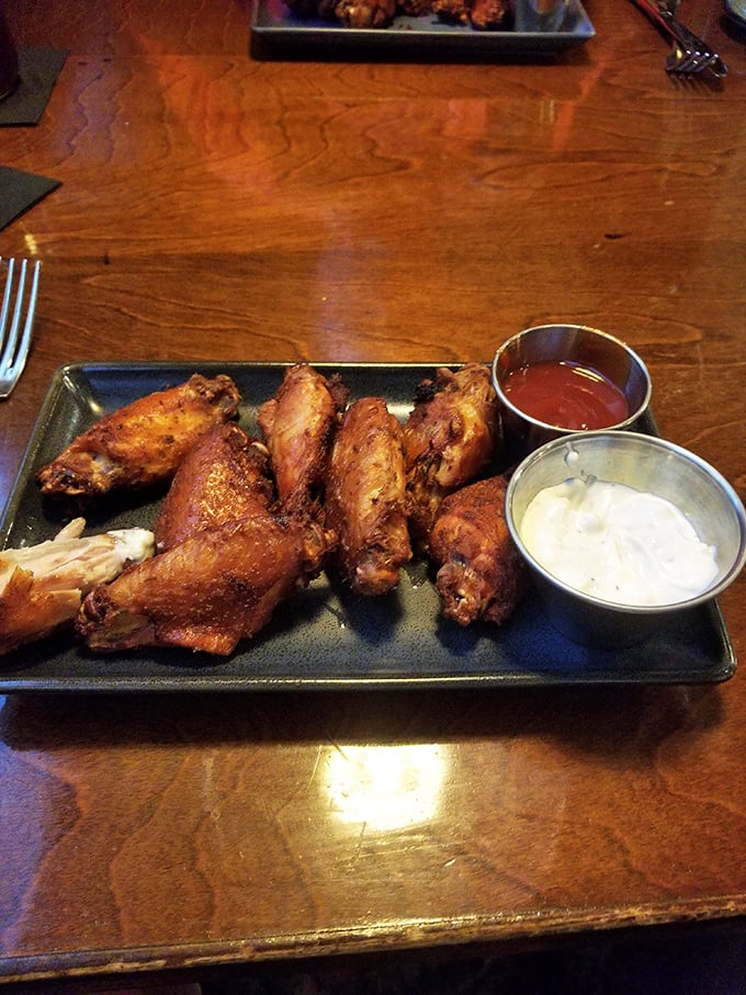 Wings that have achieved that mythical balance of crispy exterior and juicy interior, served with dipping sauces that demand to be explored.