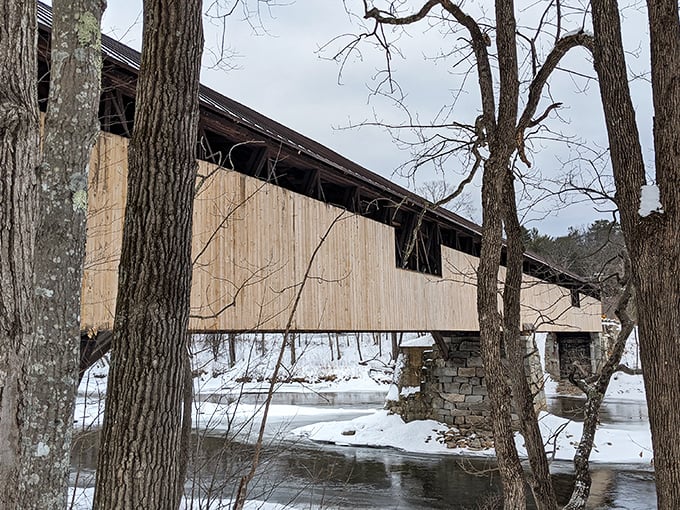 Even in winter's embrace, the Blair Bridge stands sentinel over the frozen Pemigewasset, a steadfast connection between snowy shores.
