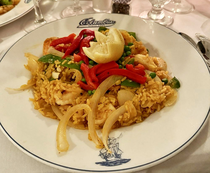 Yellow rice that glows like Florida sunshine, topped with festive red peppers. Simple? Yes. Ordinary? Never in a million Spanish afternoons.