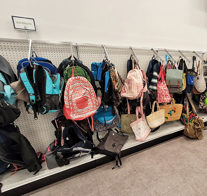 Backpacks hang like colorful fruit, ripe for the picking. Each one ready for a new adventure with a different shoulder to ride.