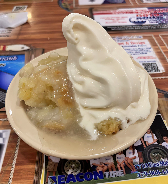 This isn't just banana pudding; it's a cloud of vanilla comfort floating above warm fruit, the kind of dessert that makes you consider skipping the main course next time.