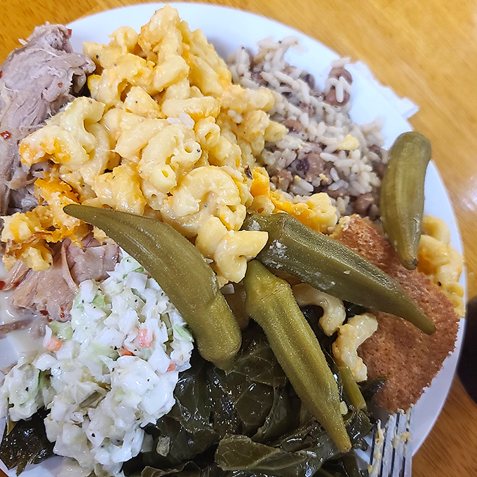 A plate of Southern heaven: creamy mac and cheese, tender pulled pork, rice, collards, okra, and coleslaw&mdash;Simply Southern's buffet in one glorious serving.
