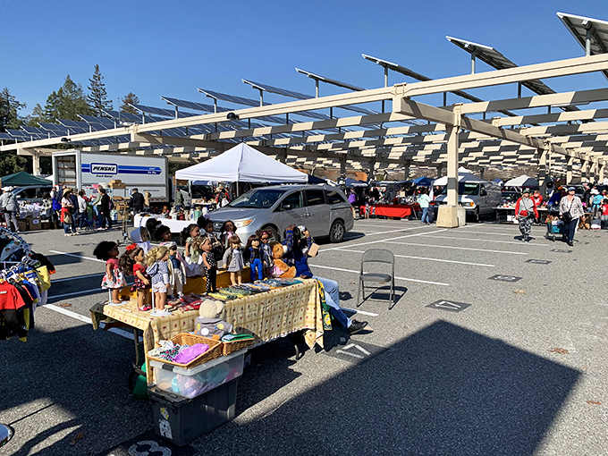 Vintage dolls stand guard over a bustling marketplace where families hunt for treasures under the watchful eye of solar panels.